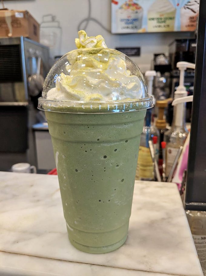The matcha frappe arrives like a cool green oasis in a desert of ordinary coffee drinks – topped with cream that's begging to leave a mustache on your upper lip.