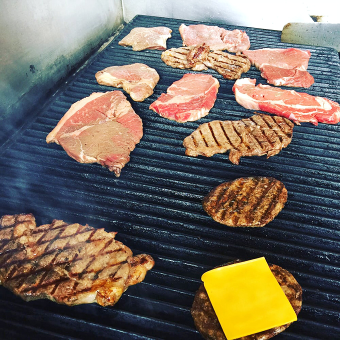 Where the magic happens &ndash; steaks and burgers sizzling on a well-seasoned grill that's probably seen more action than most Broadway stages.