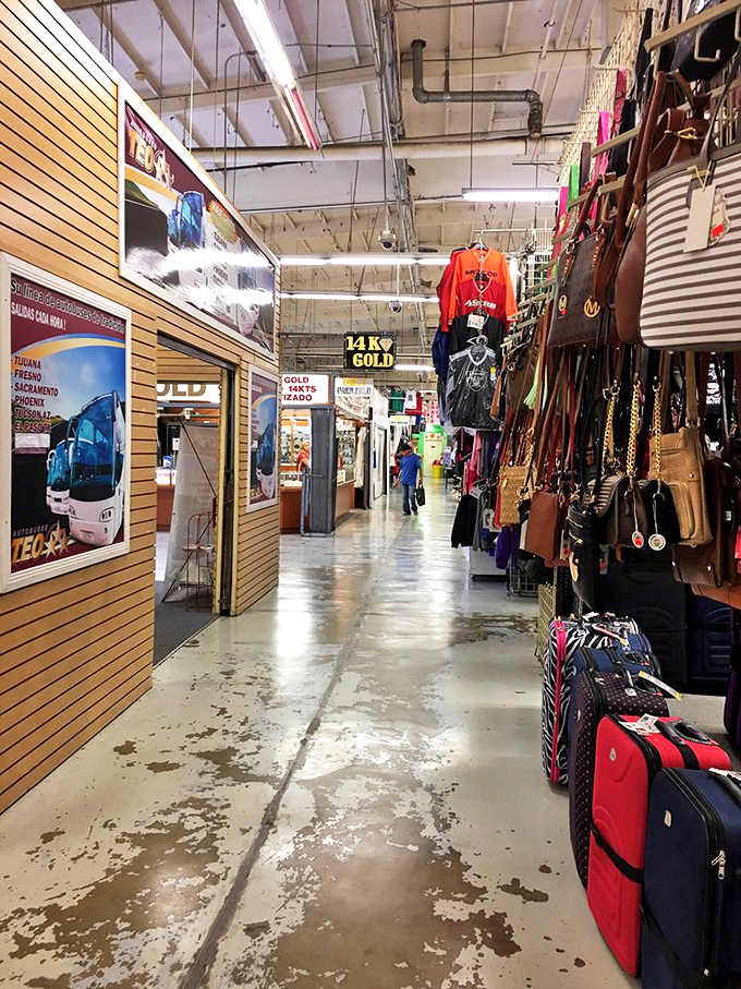 Corridors stretch like urban canyons between vendor stalls, where 14K gold signs shine like beacons and leather bags dangle like ripened fruit ready for picking.