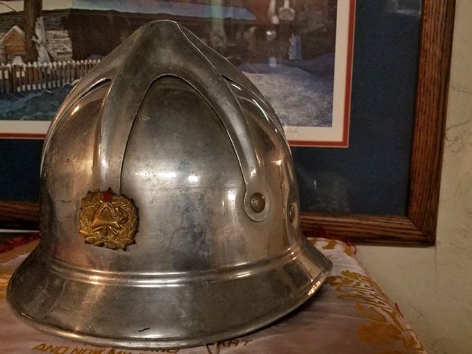 A firefighter's helmet stands as a silent tribute to service, its metal surface bearing the honorable patina of protection and duty.