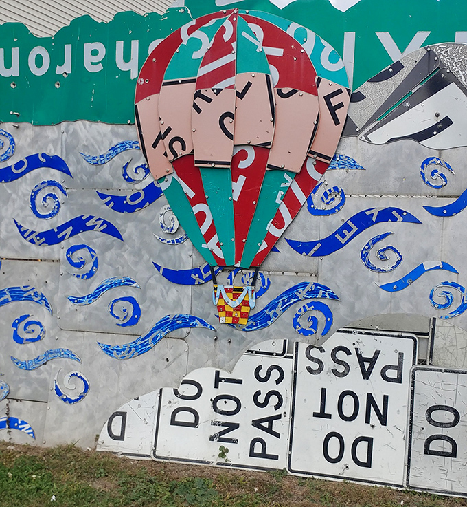 Up, up, and away! This hot air balloon crafted from "DO NOT PASS" signs ironically soars above all restrictions, floating on a sea of creative repurposing.