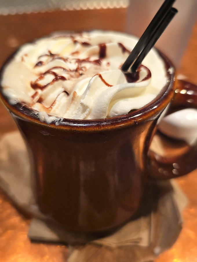 Hot chocolate that doesn't know it's not dessert. That whipped cream mountain with chocolate drizzle turns an ordinary beverage into a morning celebration.
