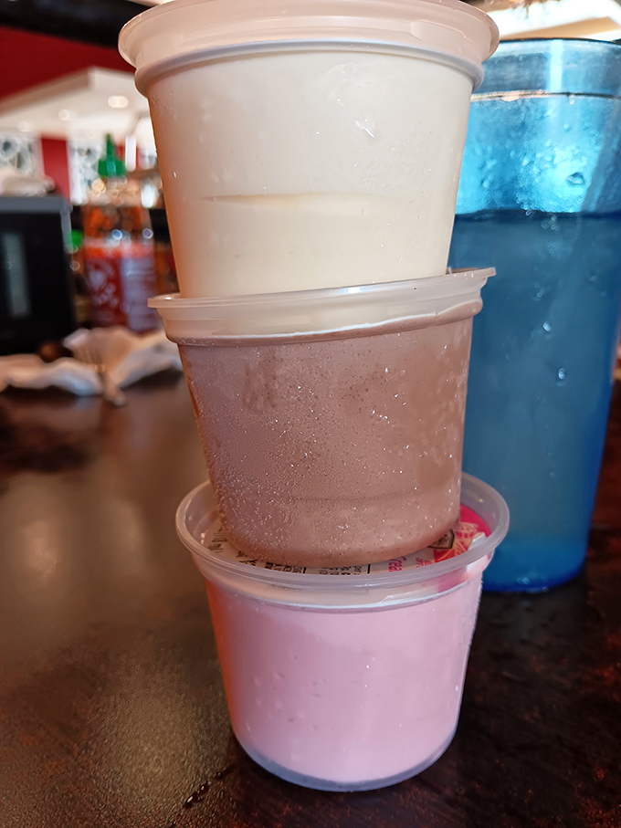 Dessert cups stacked like a tower of sweet possibilities. Vanilla, chocolate, and strawberry&mdash;the Neapolitan trifecta of happiness in convenient to-go form.