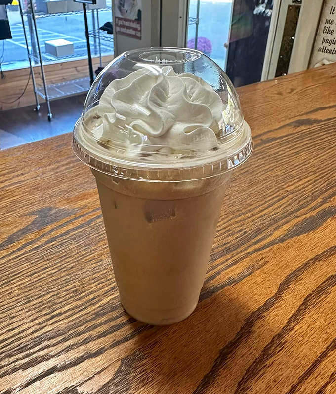 Caffeine artistry in a plastic cup. This isn't just iced coffee—it's the fuel that powers Ridgway's morning conversations.