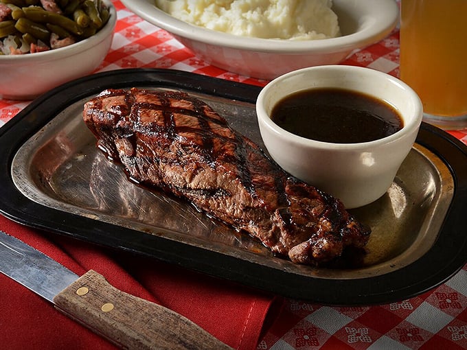 Kansas City Strip steak with a side of au jus that whispers, "Sure, chicken's famous here, but I've got secrets too."