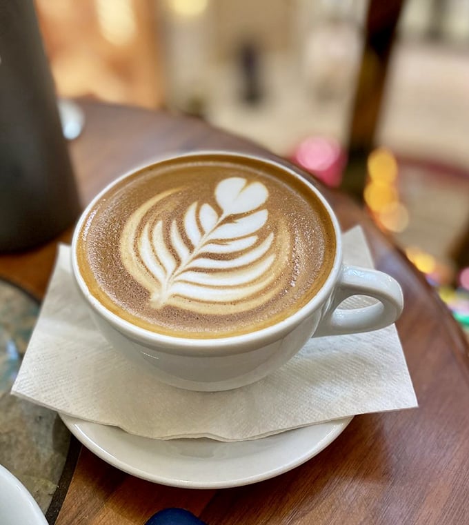 Latte art so pretty you almost don't want to drink it. Almost. That leaf design is practically begging for its Instagram moment.