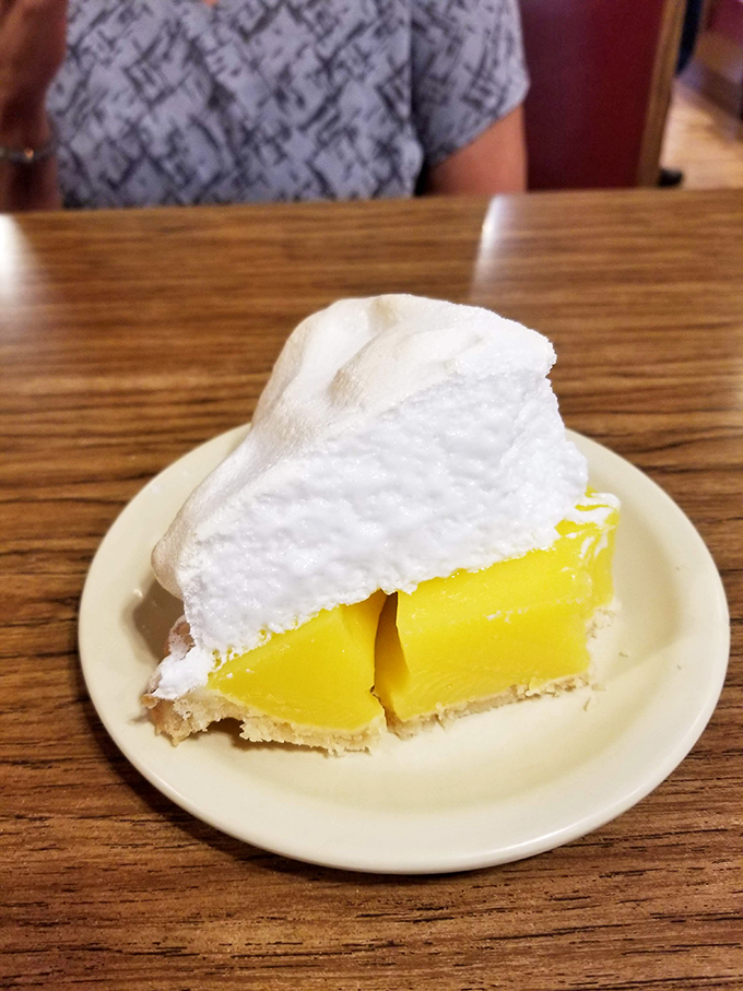 The lemon meringue pie stands tall and proud, a perfect balance of sweet and tart that would make your grandmother both jealous and proud.