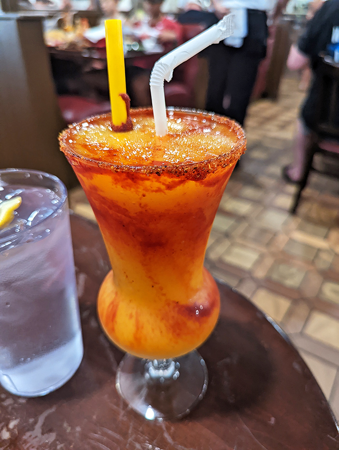 The mango margarita arrives like a sunset in a glass. That tajin-rimmed edge adds a spicy-tangy kick that perfectly balances the sweet, fruity goodness within.