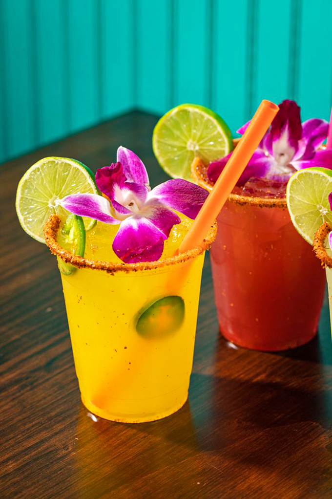 Margaritas dressed for their own quincea&ntilde;era. These vibrant cocktails with their flower garnishes and tajin rims are ready for their Instagram moment.