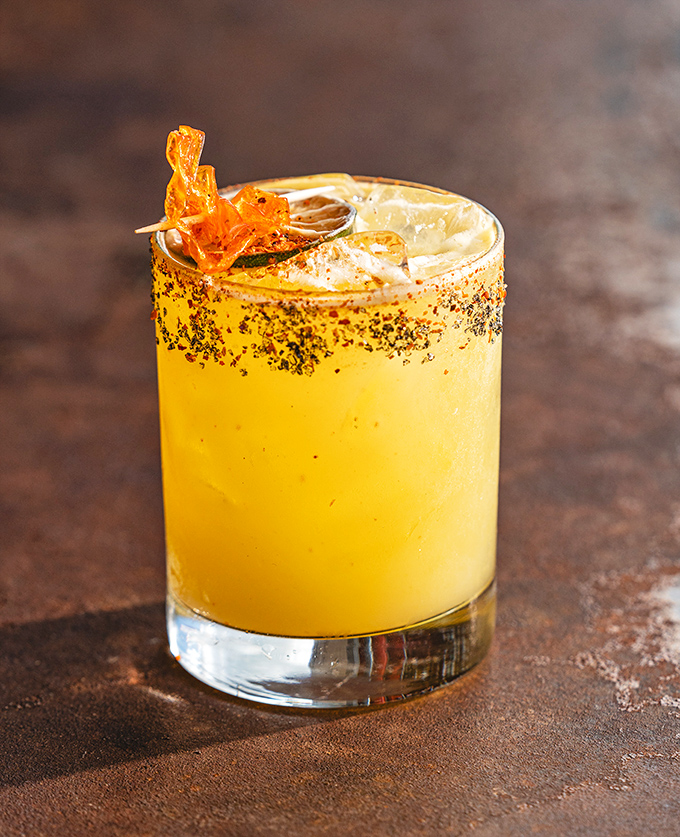 This cocktail doesn't just quench thirst&mdash;it tells stories. The rim dusted with spice, the caramelized garnish, the sunshine-yellow liquid promising Kentucky bourbon magic.