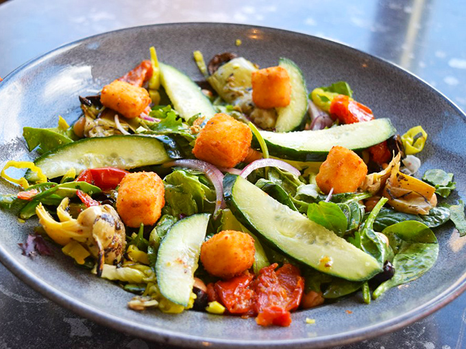 A vibrant salad that doesn't apologize for being healthy&mdash;crisp vegetables, creamy avocado, and golden croutons create a refreshing counterpoint to mac and cheese indulgence.