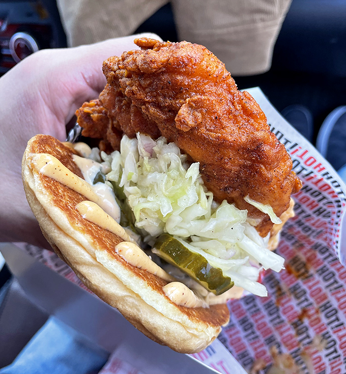 Architecture meets artistry in this perfect sandwich. Crispy chicken, cool slaw, and pickles create the holy trinity of handheld happiness.