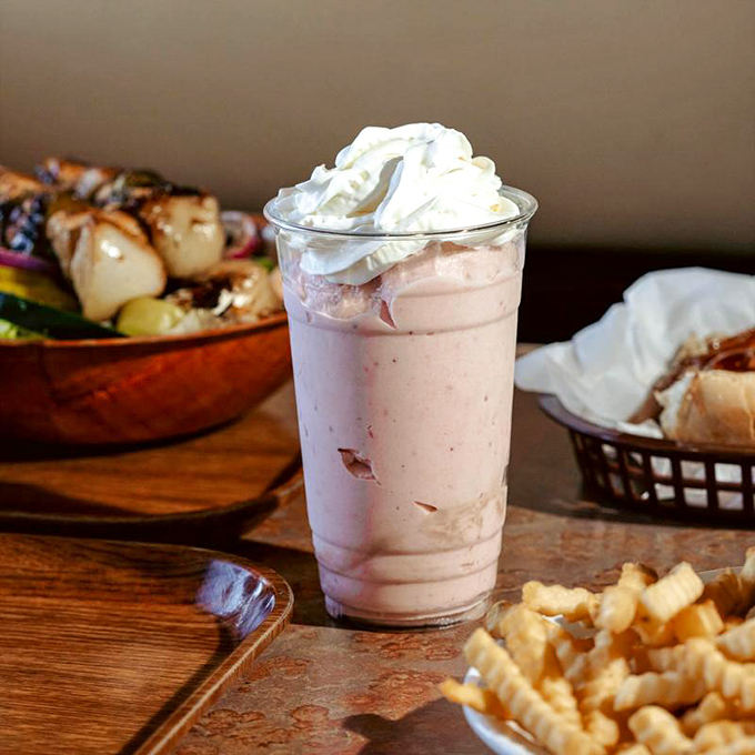 A milkshake thick enough to require serious straw commitment, flanked by fries in a partnership that nutritionists hate but your soul desperately needs.