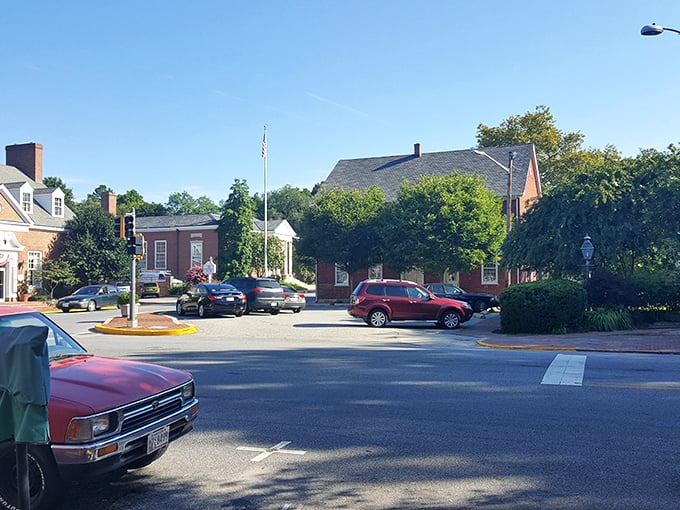 Brick buildings and American flags create that Norman Rockwell feeling that makes you wonder if you've stepped into a painting rather than a parking lot.