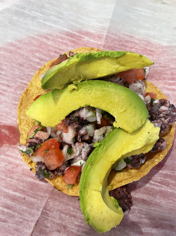 Fresh avocado crowns this octopus tostada like jewelry. It's seafood elevated to art form&mdash;the kind of dish that makes you pause mid-bite in appreciation.