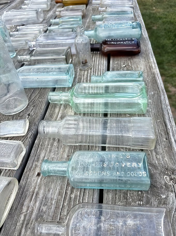 Antique glass bottles catch the light, each one telling a story from another era. Medicine, soda, or snake oil - history in transparent form.