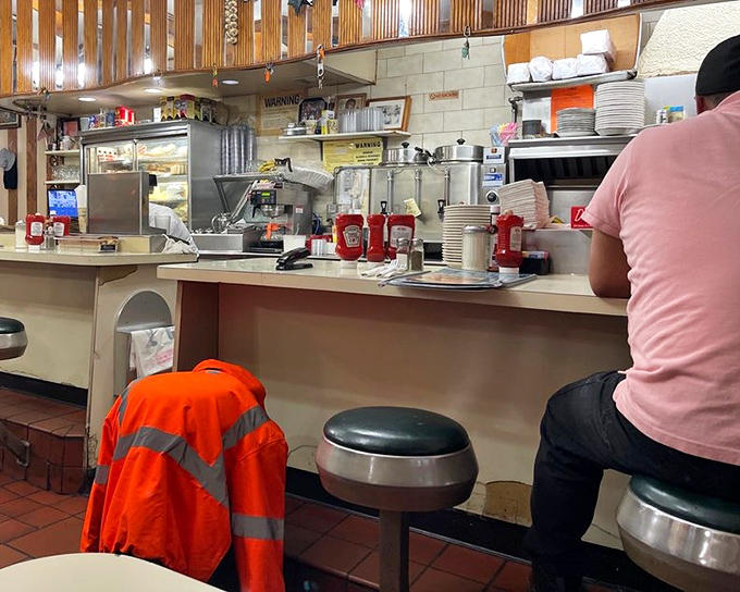 The counter&mdash;where solo diners become temporary family, watching short-order cooks perform their sizzling ballet just feet away.