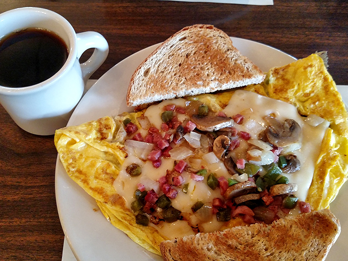An omelet that's seen more fillings than a dentist's office. That coffee isn't just a beverage&mdash;it's the necessary companion for this breakfast adventure.