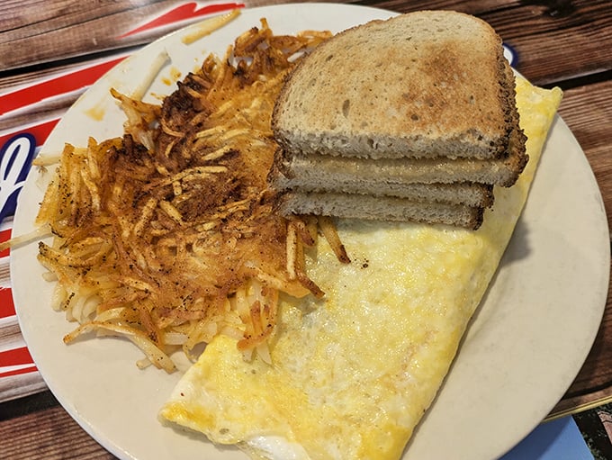 The holy trinity of breakfast: fluffy omelet, crispy hash browns, and toast. Simple perfection that chain restaurants can only dream about.