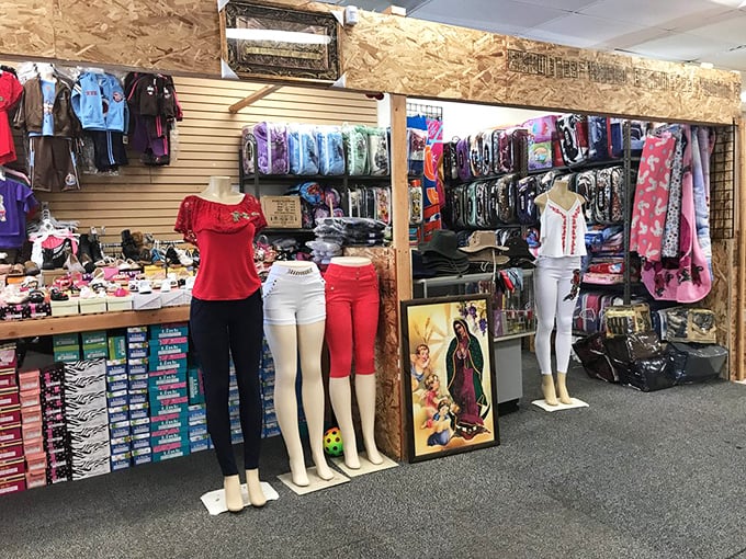 A vendor's stall transforms into a boutique experience with organized displays and mannequins. The wood-paneled walls add rustic charm to modern merchandise.