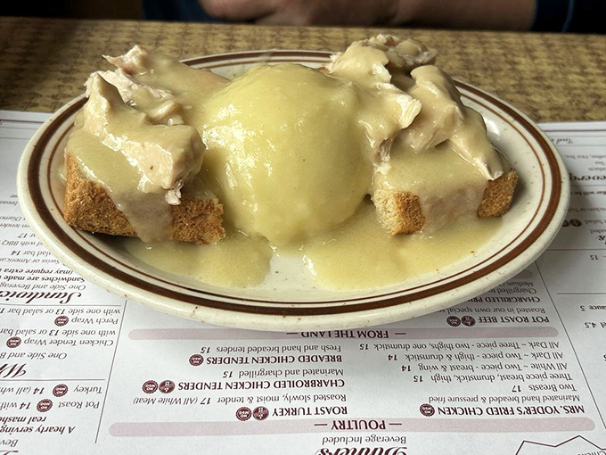 The open-faced hot turkey sandwich&mdash;where bread becomes a throne for turkey royalty, all gloriously drowning in gravy that should be classified as a controlled substance.