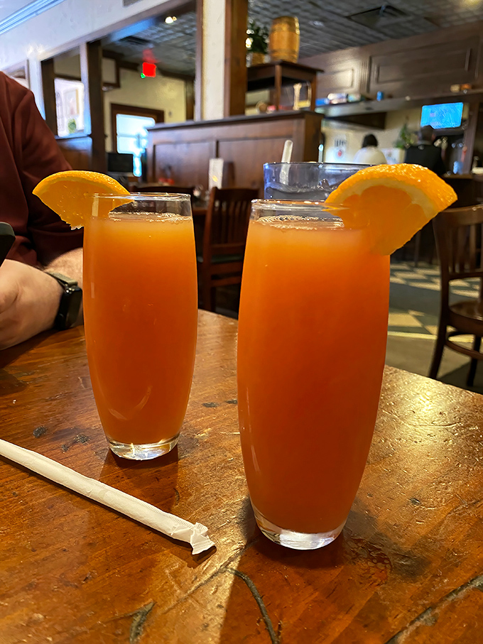 Fresh-squeezed orange juice served in proper glasses with actual orange slices&mdash;because sometimes the simplest pleasures are the most impressive.