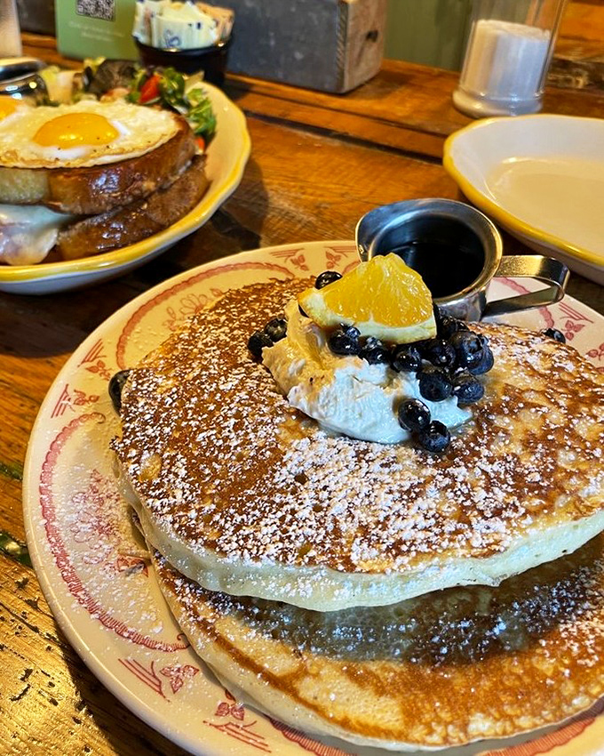 Pancakes that look like they've been dusted with powdered sugar snow, crowned with fresh berries and whipped cream. Breakfast or dessert? Yes.