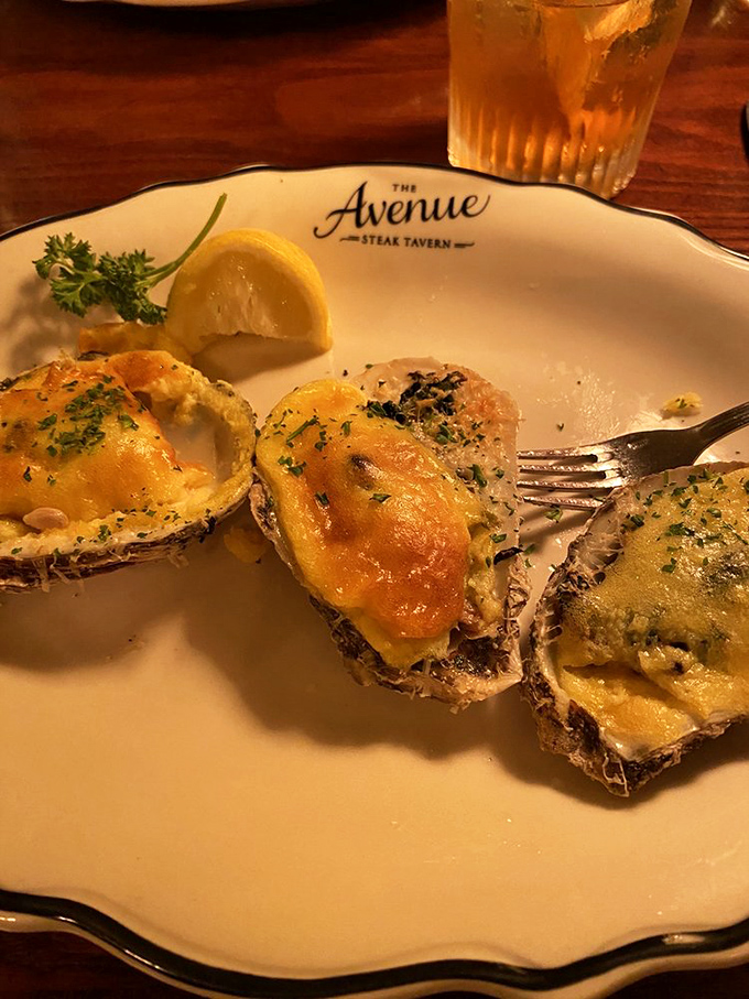 Oysters Rockefeller done right &ndash; bubbling with cheese and herbs. The kind of appetizer that makes you consider skipping the main course.