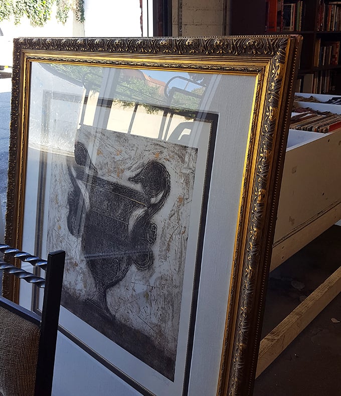 An ornate gold frame elevates artwork that might have once hung in someone's formal dining room. Thrifting's greatest magic? Unexpected elegance at bargain prices.