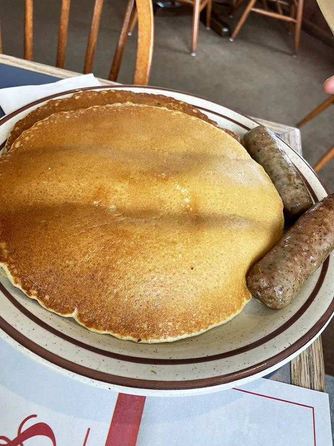 That pancake is so perfectly golden it could win a beauty pageant, while those sausage links are its worthy sidekicks.
