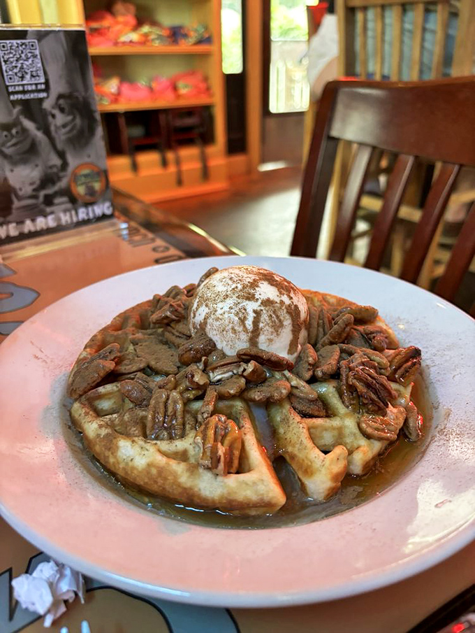 Breakfast nirvana achieved: golden waffle, crunchy pecans, and that scoop of heaven on top. Worth setting your alarm for.