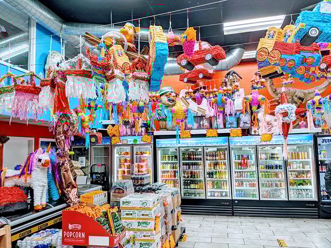 Colorful pi&ntilde;atas dangle from the ceiling like sugary constellations, promising both decoration and the ultimate candy delivery system.