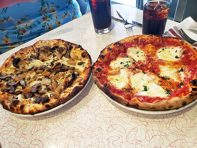 Two pizzas engaged in a friendly debate about whether simplicity or complexity wins the day. Spoiler alert: your taste buds declare it a delicious tie.