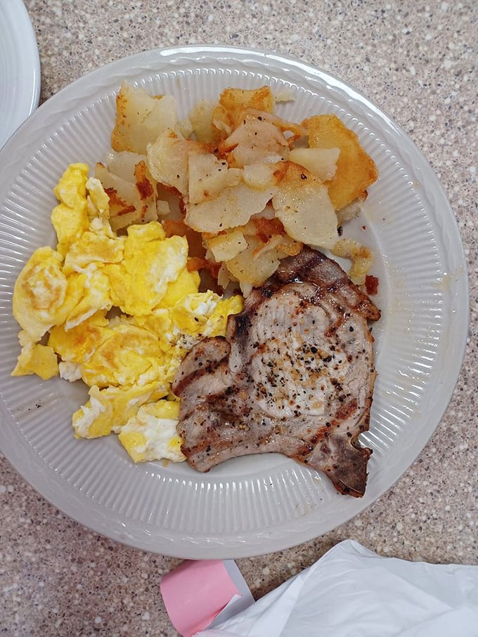 The breakfast trinity: perfectly grilled pork chop, golden eggs, and potatoes crisped to perfection. Simple food done right never goes out of style.