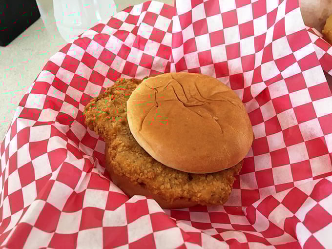 The pork tenderloin sandwich: where the meat dramatically outperforms the bun in this Midwestern classic.