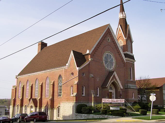 This brick church doesn't just reach toward heaven&mdash;it anchors the community to earth. Those stained glass windows have filtered Sunday morning light for generations.