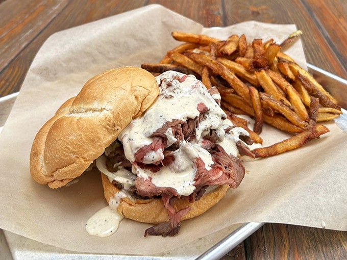 The pulled pork sandwich&mdash;where smoke meets soul. A testament to the fact that sometimes the simplest presentations deliver the most profound flavors.