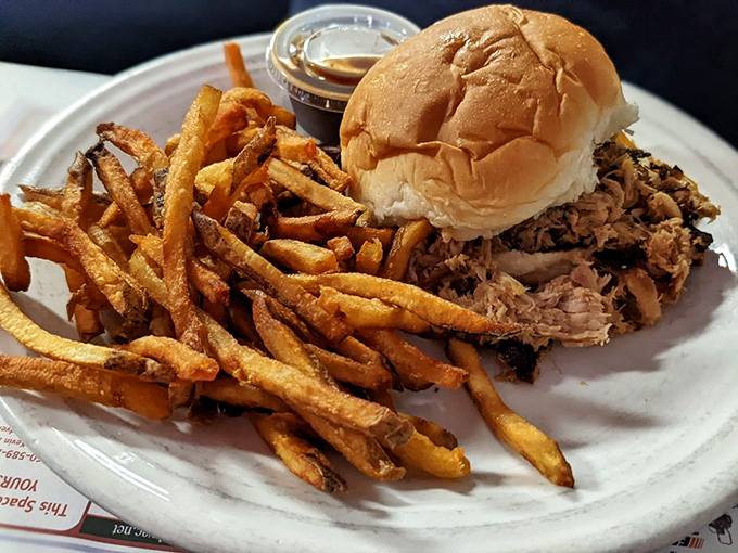 A pulled pork sandwich that doesn't need fancy tricks—just honest barbecue flavor, hand-cut fries, and the promise of a post-meal nap.