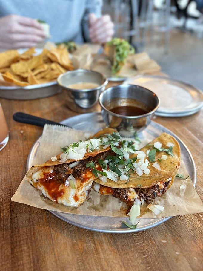 The quesabirria taco: crispy, cheesy, beefy perfection. One bite of this cross-cultural masterpiece and you'll understand why people line up in the snow.