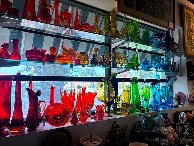 A rainbow of vintage glassware catches the light like a time-traveling prism, each piece telling colorful stories of dinner parties past.