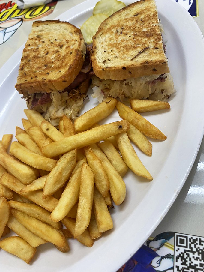 The Reuben sandwich&mdash;where corned beef, sauerkraut, and grilled rye bread create the holy trinity of deli perfection with fries as faithful disciples.