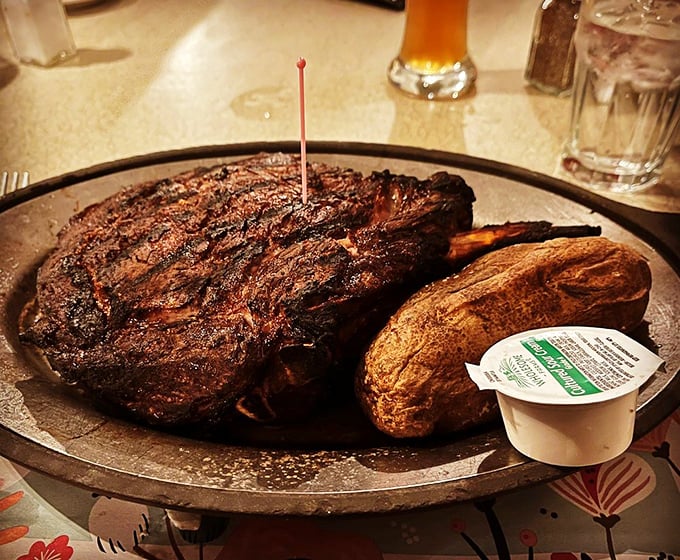 A steak so perfectly charred and massive it deserves its own ZIP code. The baked potato stands by like a loyal sidekick.