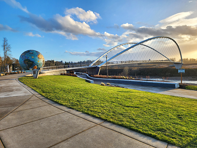 Riverfront Park's pedestrian bridge arcs gracefully over the water, proving that functional infrastructure can double as public art.
