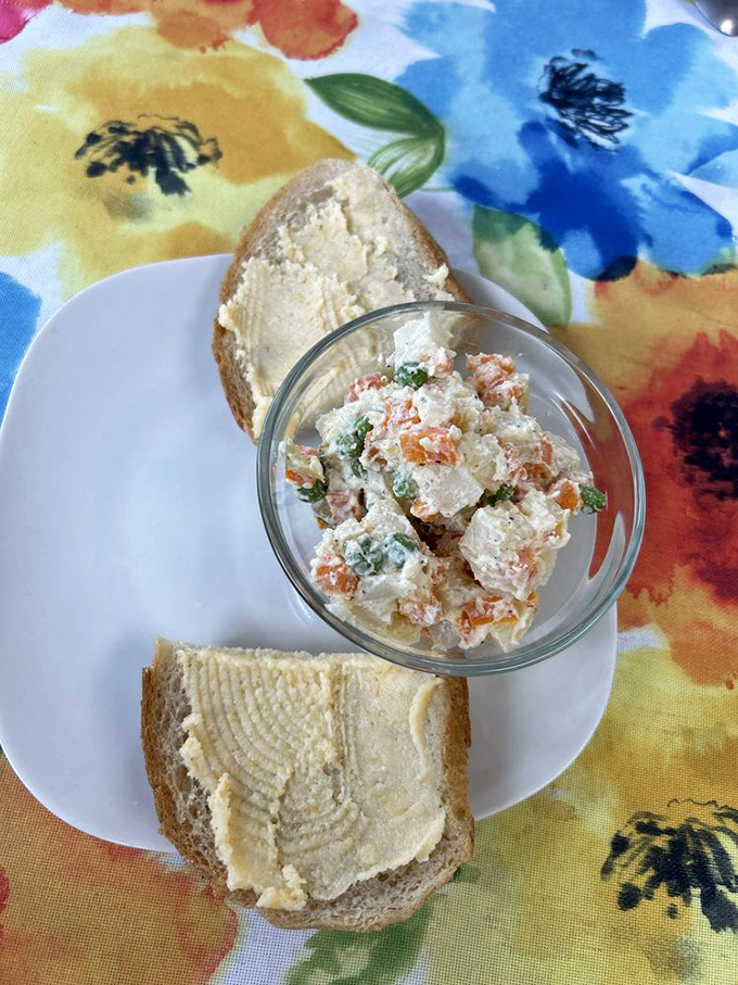A Russian salad that makes potato salad exciting again. Creamy, colorful, and served with bread that's just waiting for its close-up.