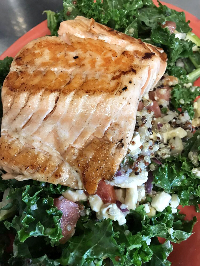Perfectly grilled salmon atop a bed of vibrant kale and quinoa. Who says diner food can't be both virtuous and delicious?
