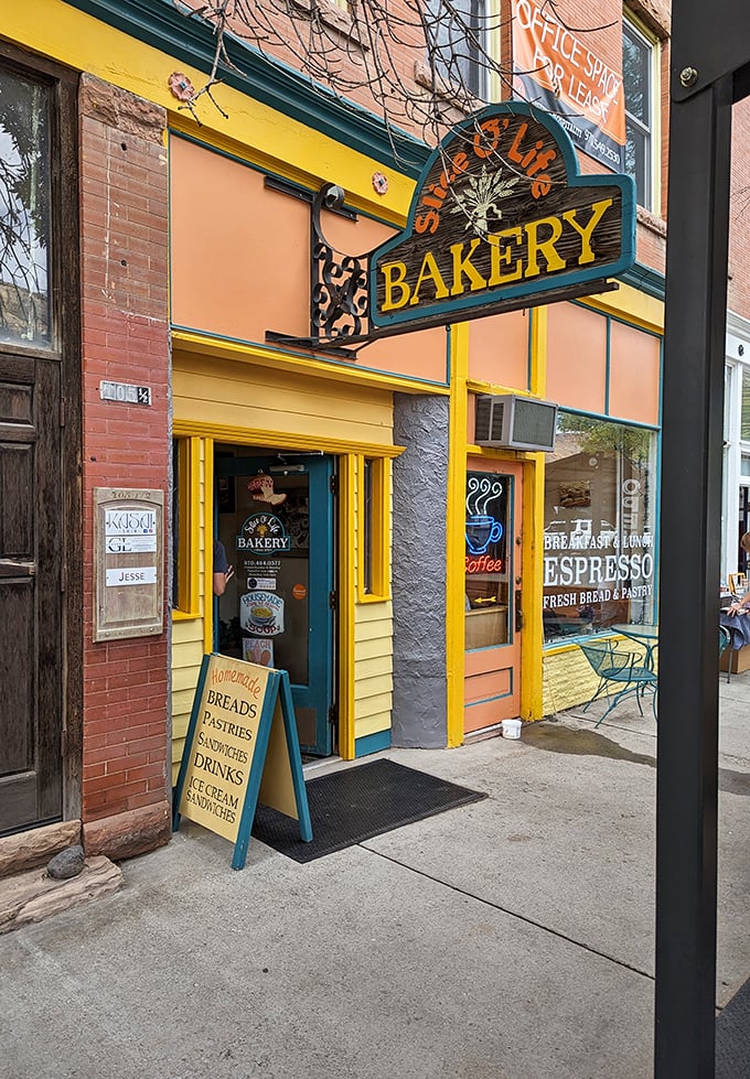 Slice O' Life Bakery's cheerful yellow facade promises morning salvation in the form of fresh-baked bread and locally roasted coffee.