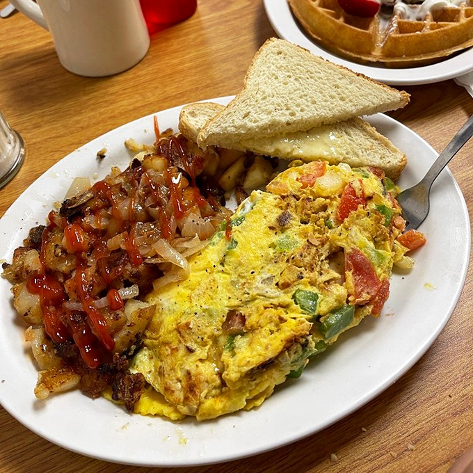 This isn't just an omelet; it's a Southwestern flavor fiesta with home fries that could make a potato farmer proud.