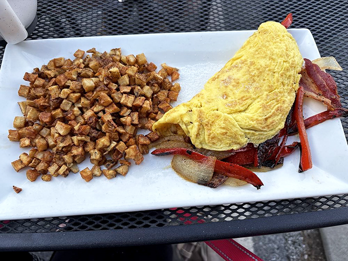 Golden omelet perfection meets crispy breakfast potatoes&mdash;a plate that says "good morning" more effectively than three cups of coffee.