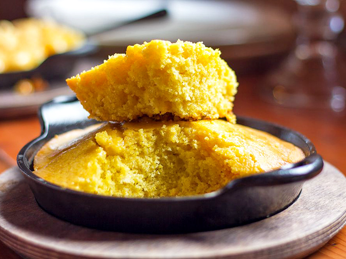 Yellow cornbread glowing like the sun in its cast iron skillet &ndash; waiting to be slathered with honey butter and all your affection.