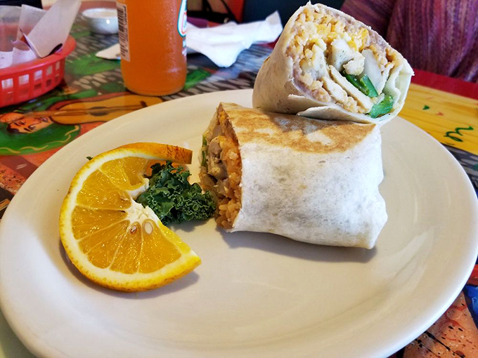 This burrito isn't just wrapped&mdash;it's embraced by a flour tortilla that knows exactly what it's doing. The orange slice adds a touch of sunshine.
